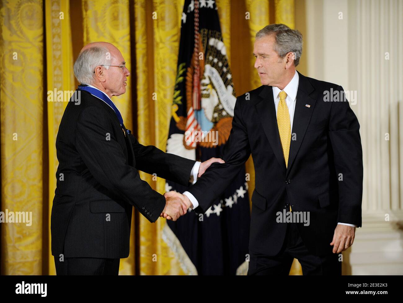 US President George W. Bush (R) shakes hands with former Australian ...
