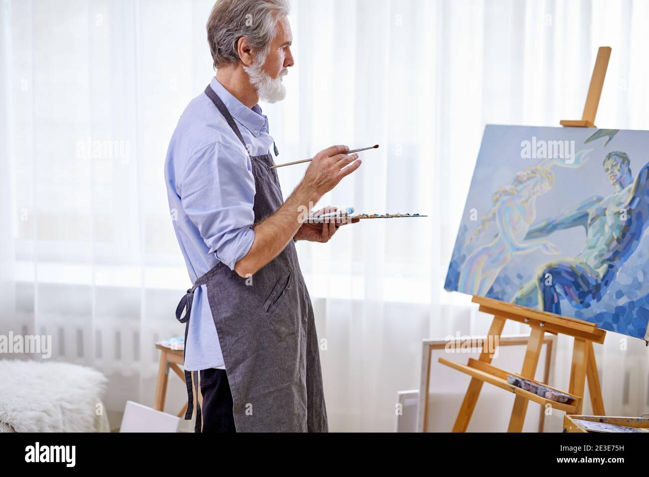 artist holding creating masterpiece using paintbrush, stand near canvas ...