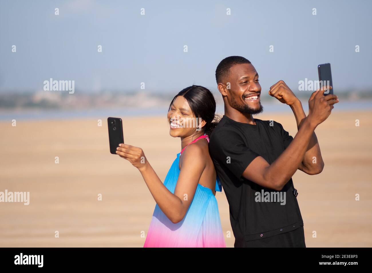 Two friends standing back to back hi-res stock photography and images ...