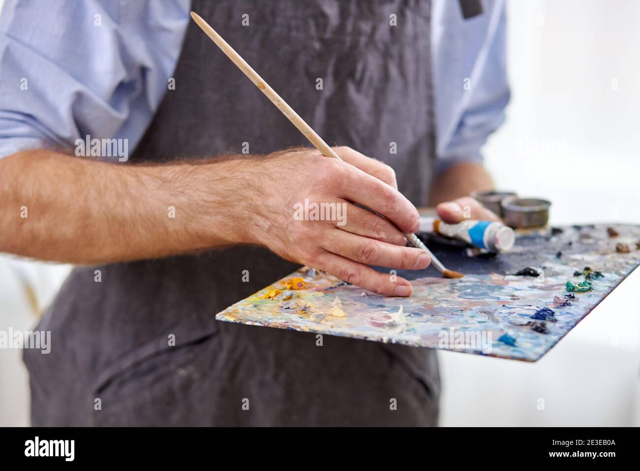 artist mix colors on palette holding in hand close up. creativity, art ...