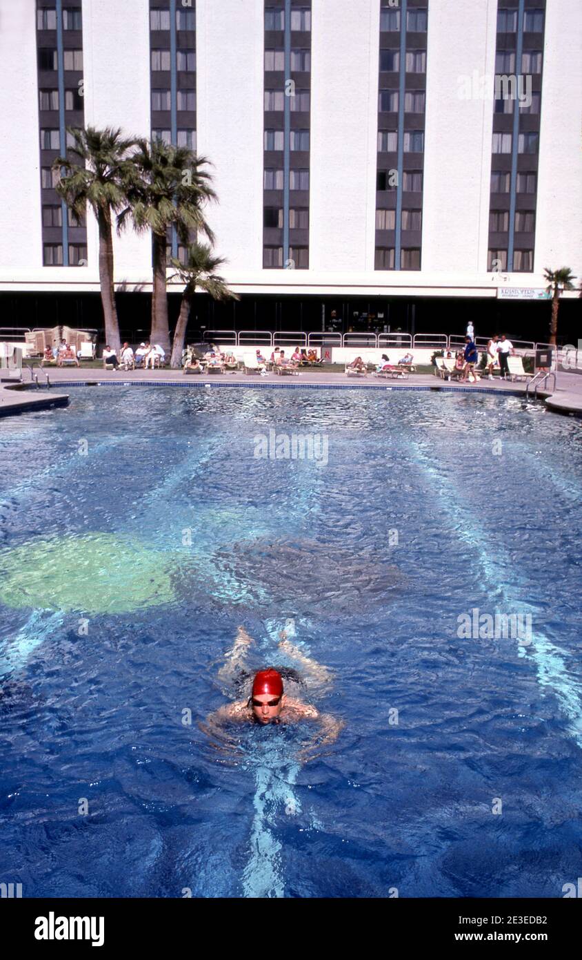 Man with cap and goggles swimming laps at the pool at the Riviera Hotel ...