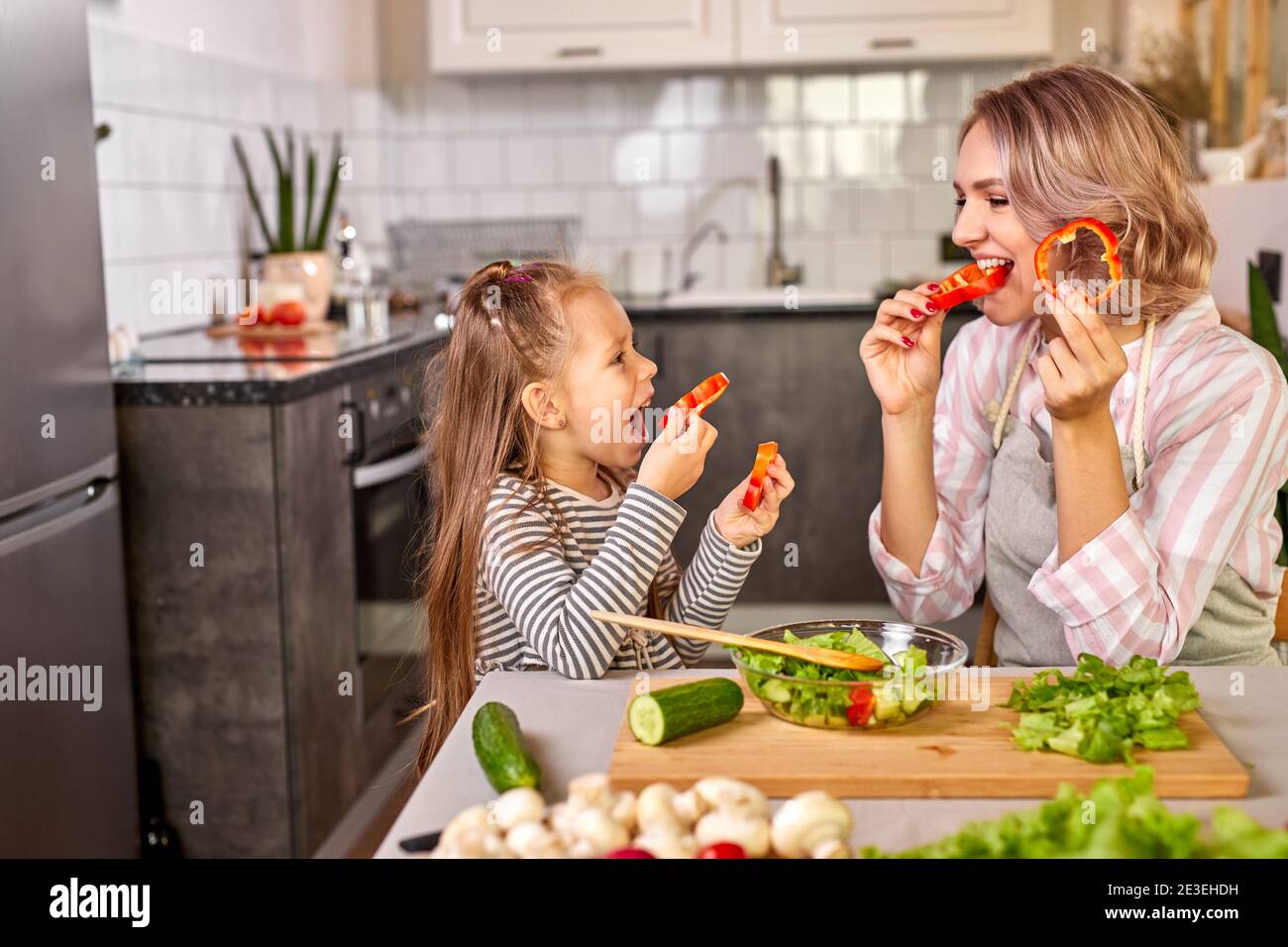 family have fun while cooking in the kitchen, adorable woman with child ...