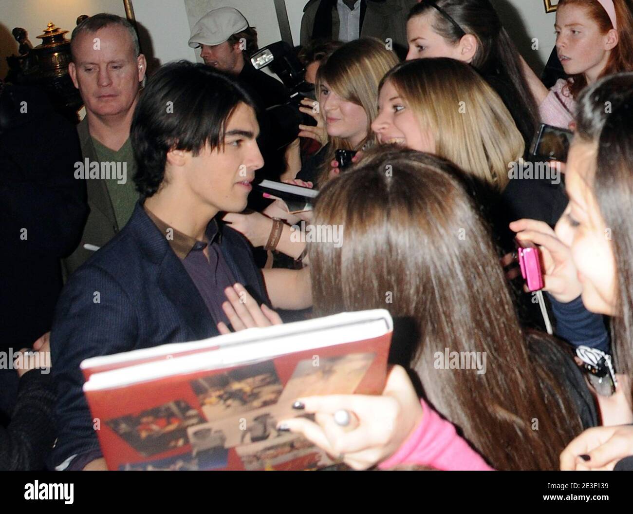 Joe Jonas signs autographs for fans during the unveiling of the Jonas ...