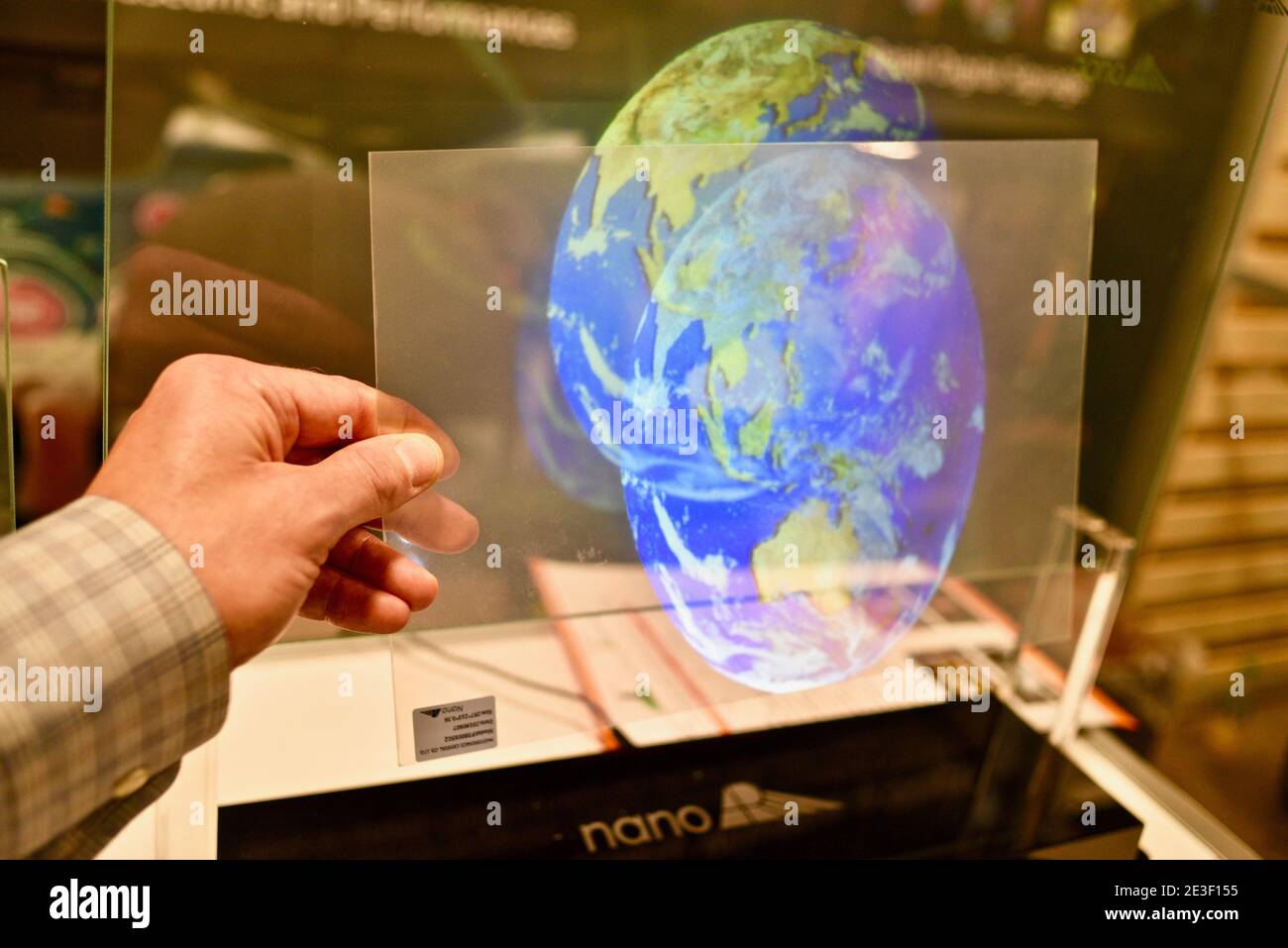Hand holding transparent 360-degree holographic with image display ...