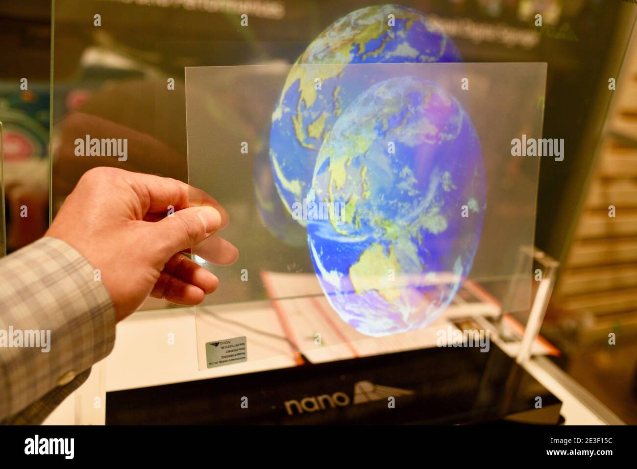 Hand holding transparent 360-degree holographic with image display ...