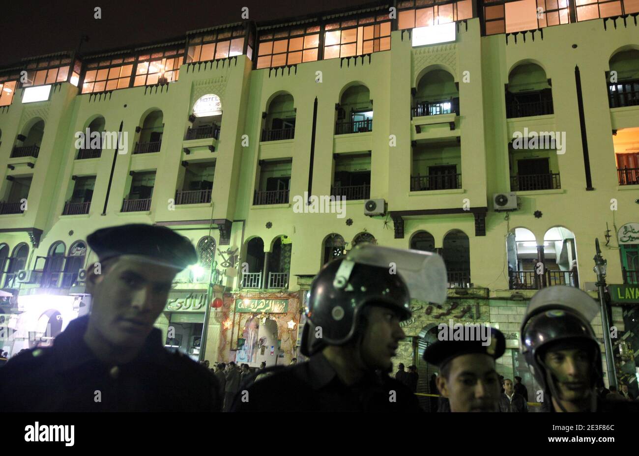 Egyptian police officers cordon off the crime scene after the double ...
