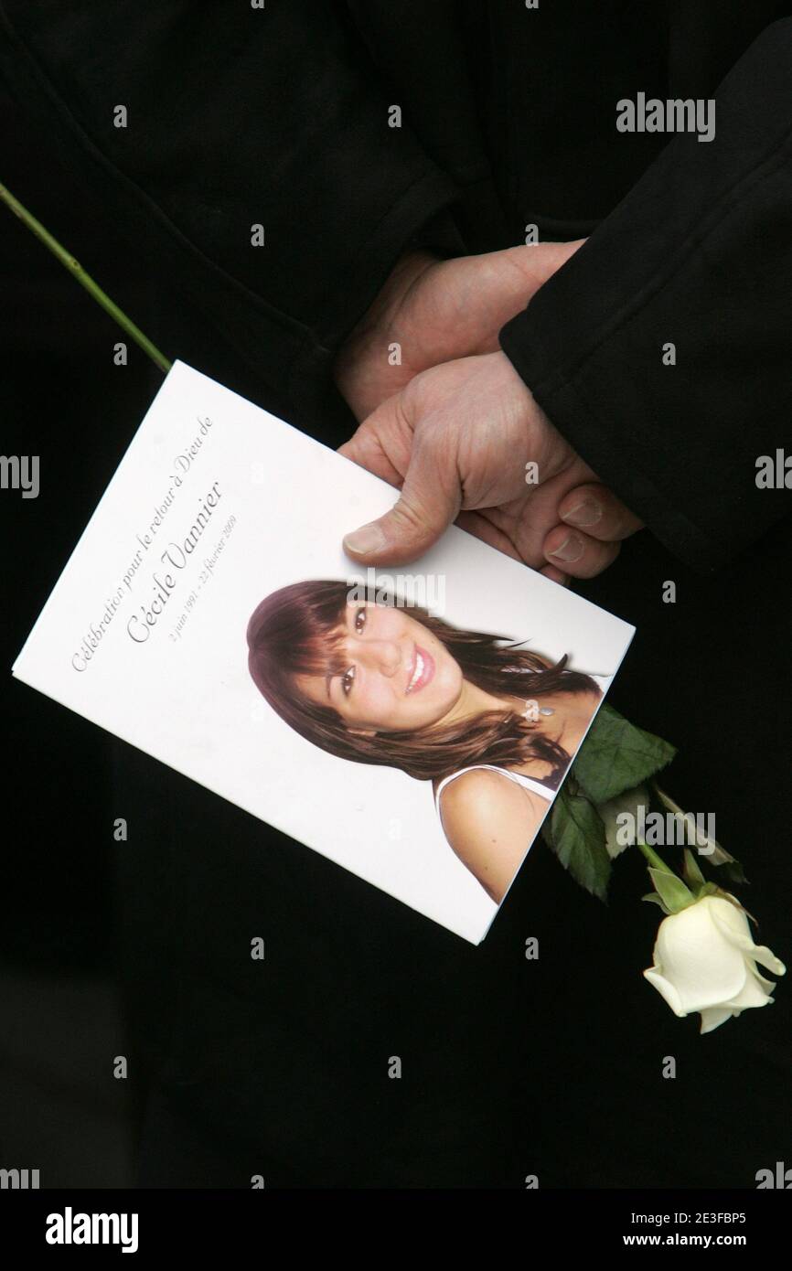 A person holds a leaflet bearing the photo of late French student ...