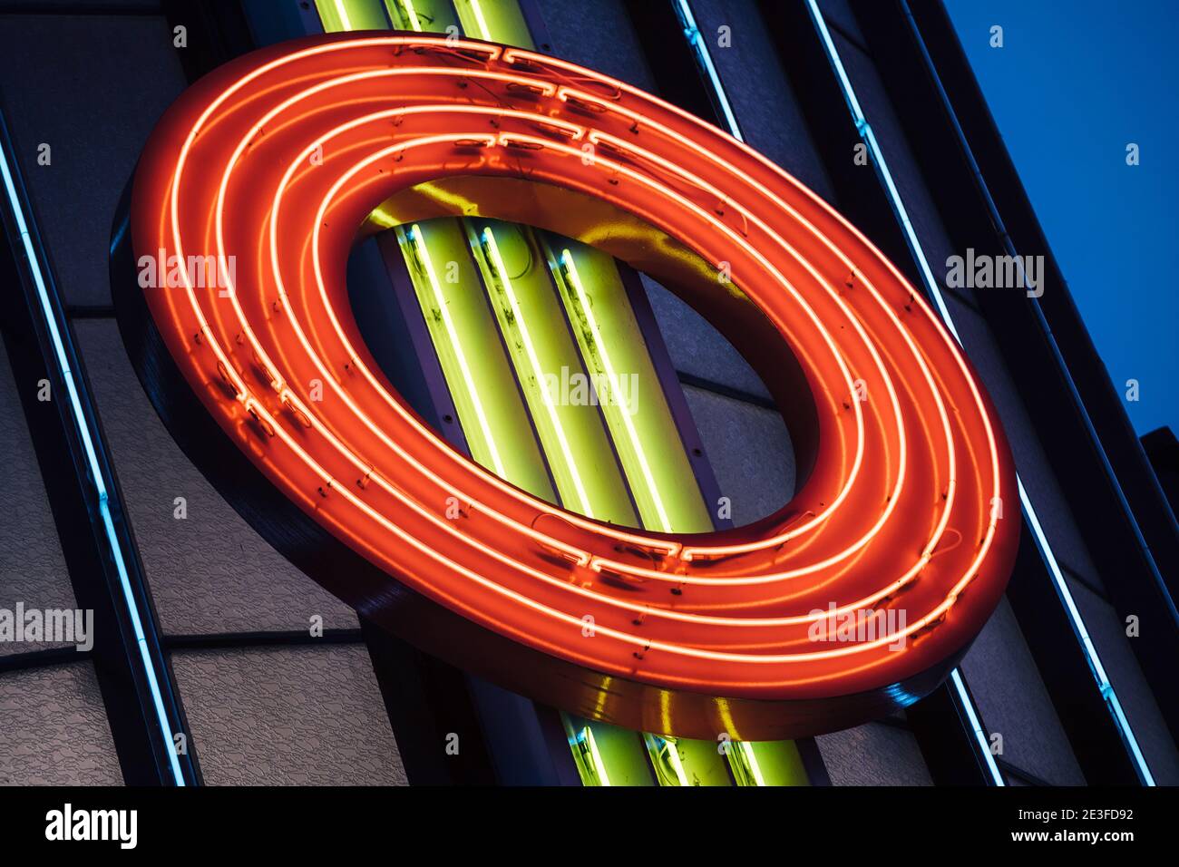 Vintage Neon light tubes forming letter O on the metallic roof top with ...