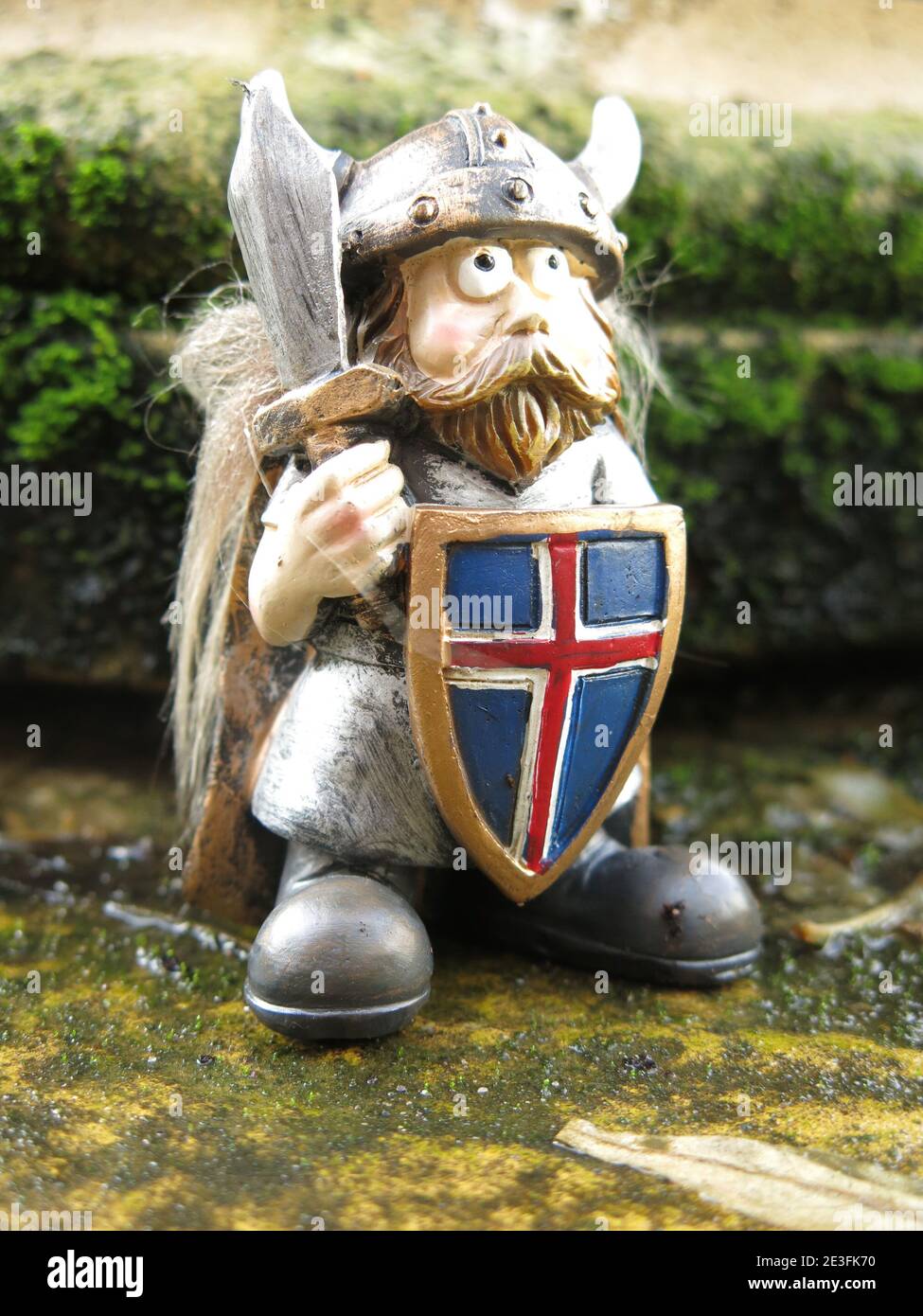 A miniature Viking figure wearing a horned helmet, in battle regalia ...