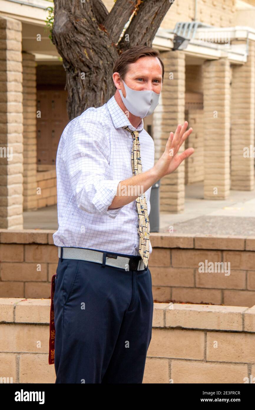 Carrying their educational materials in a shoulder bag and a baggage ...