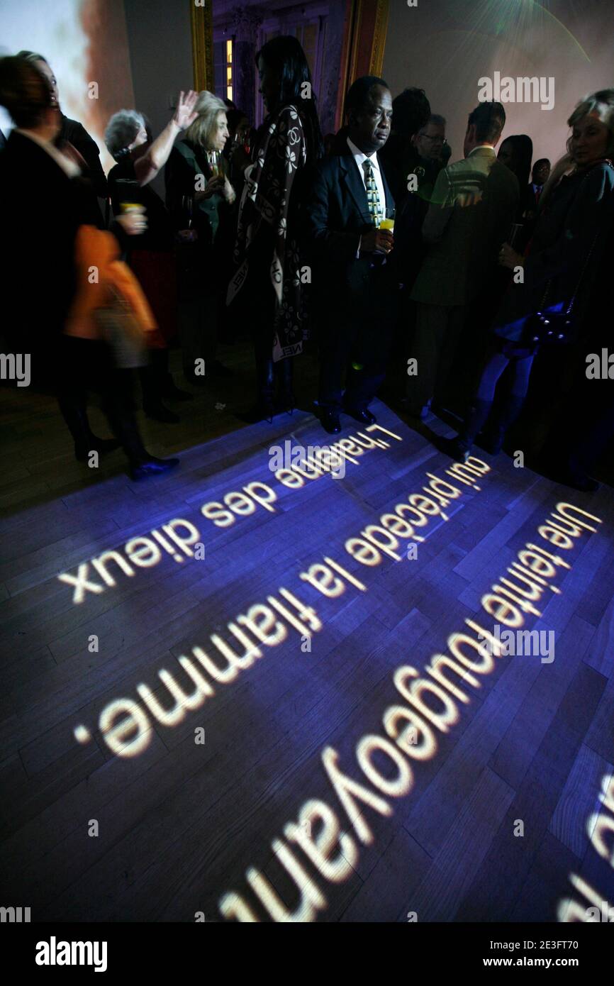 Invited guest look at the projected artwork of Patrick Rimoux inside ...