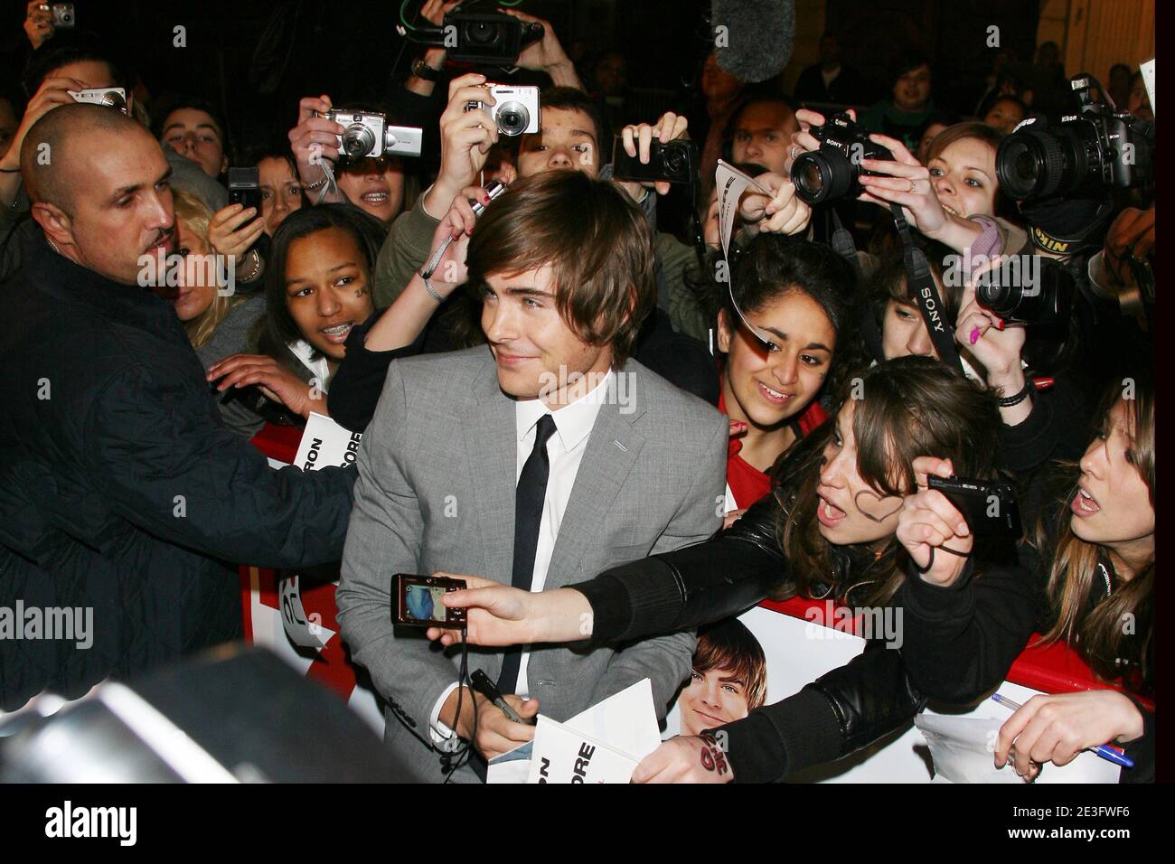 Actor Zac Efron signs autographs to his French fans as he arrives at ...
