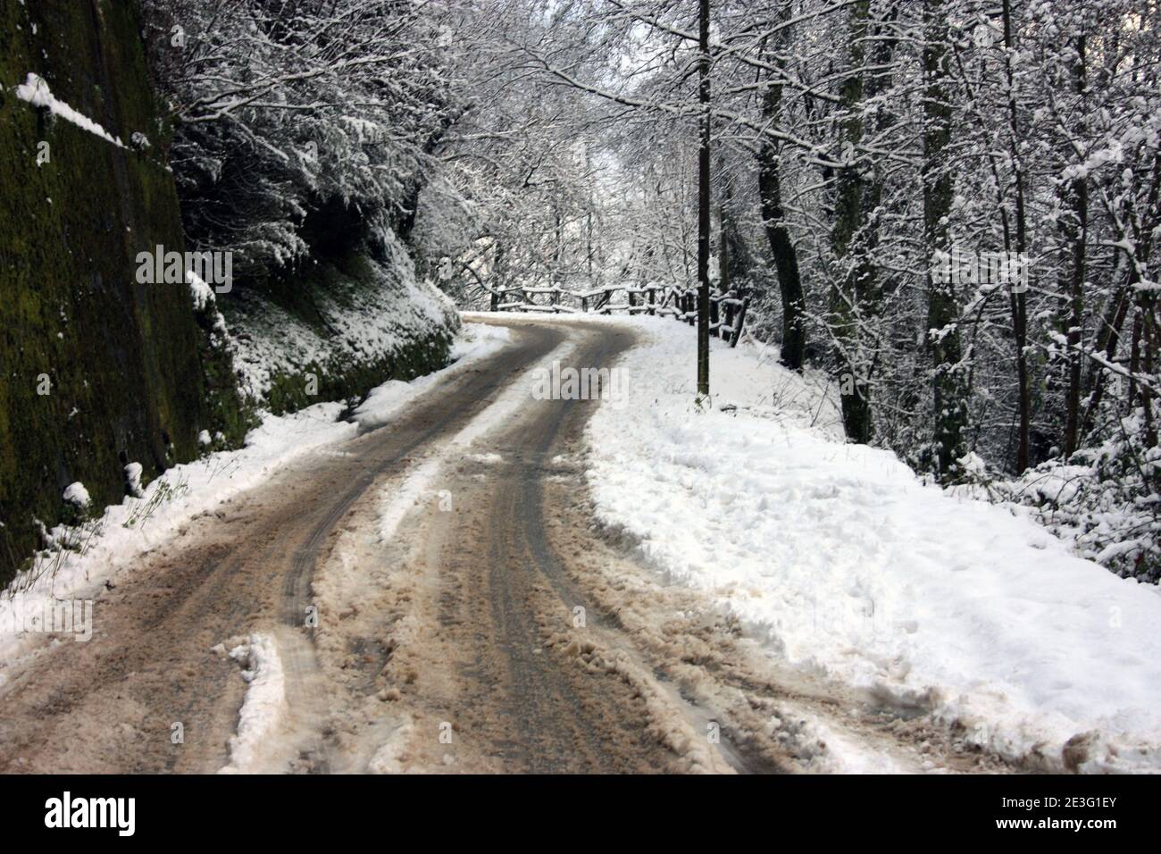 Bumpy and poorly paved road trail on mountain winter snow white dirt ...