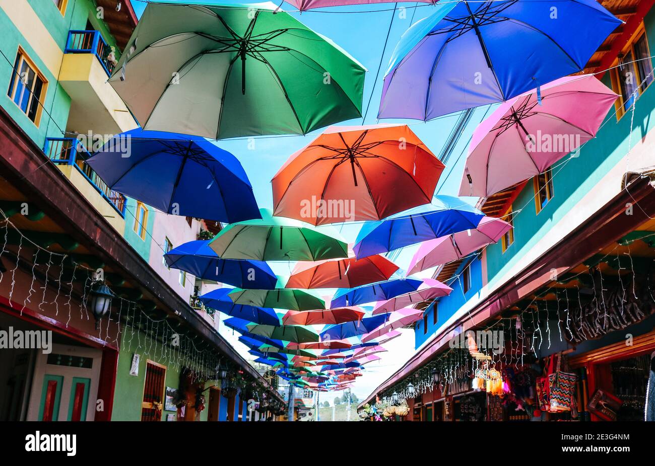 Street with Colourful umbrella decorations in Pueblo Guatape, Colombia ...