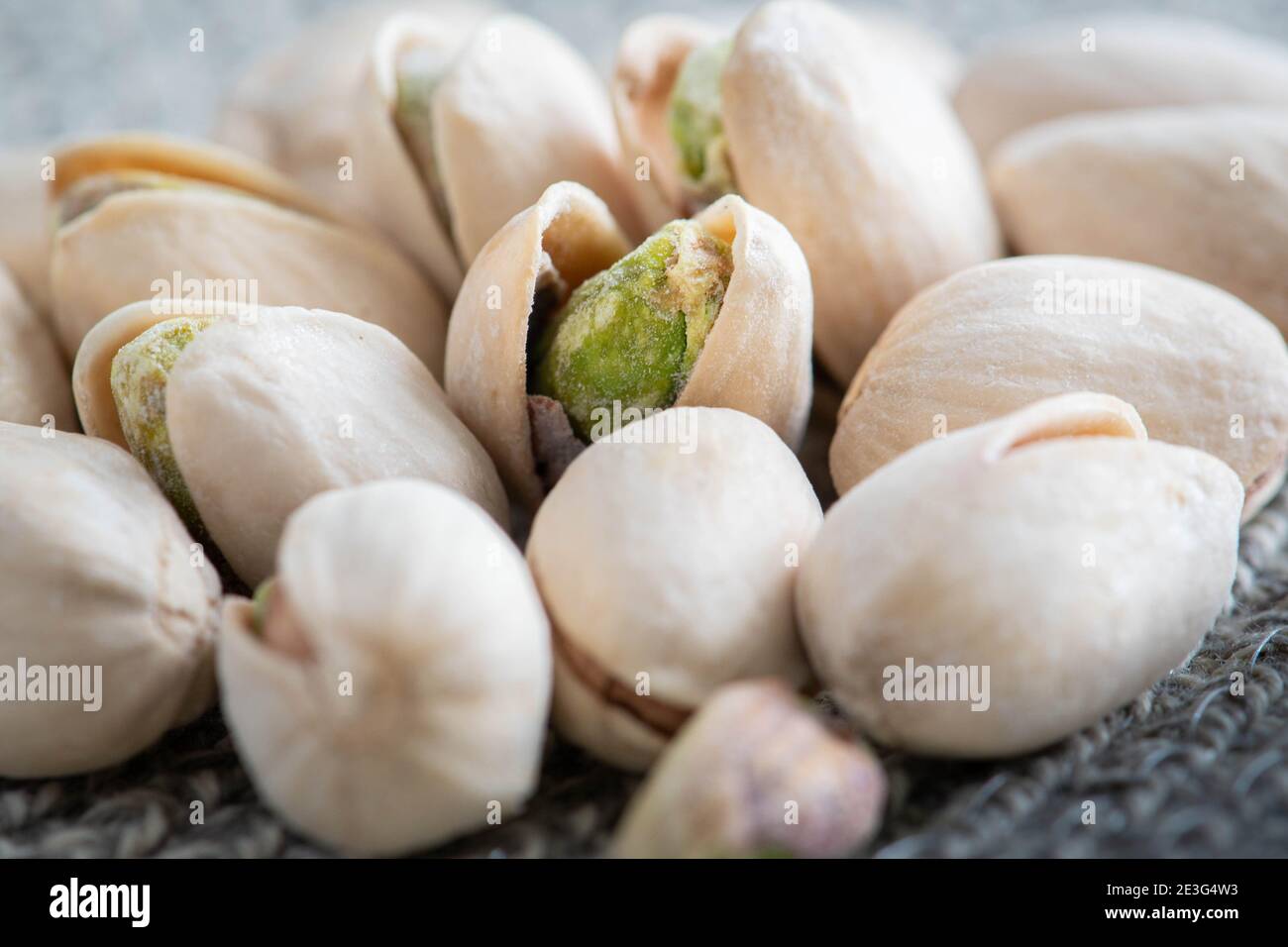 Pistachios close up macro shot featuring an open pistachio shell with ...
