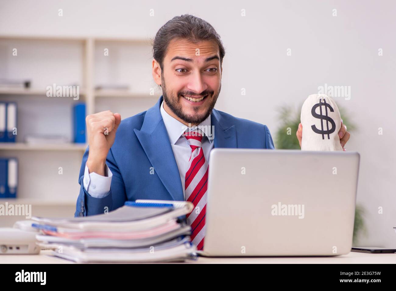 Young employee in remuneration concept Stock Photo - Alamy