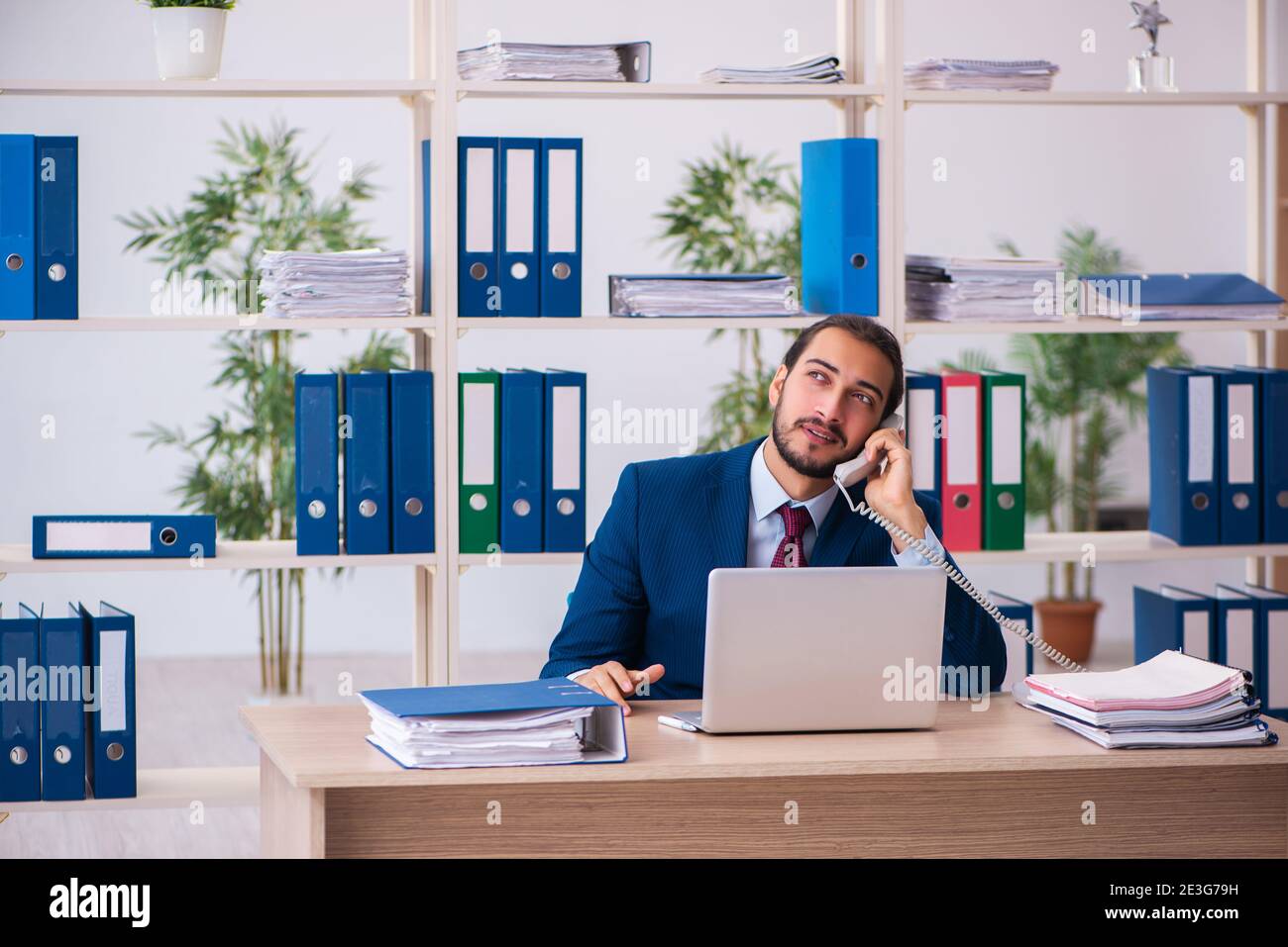 Young employee and too many work in the office Stock Photo - Alamy