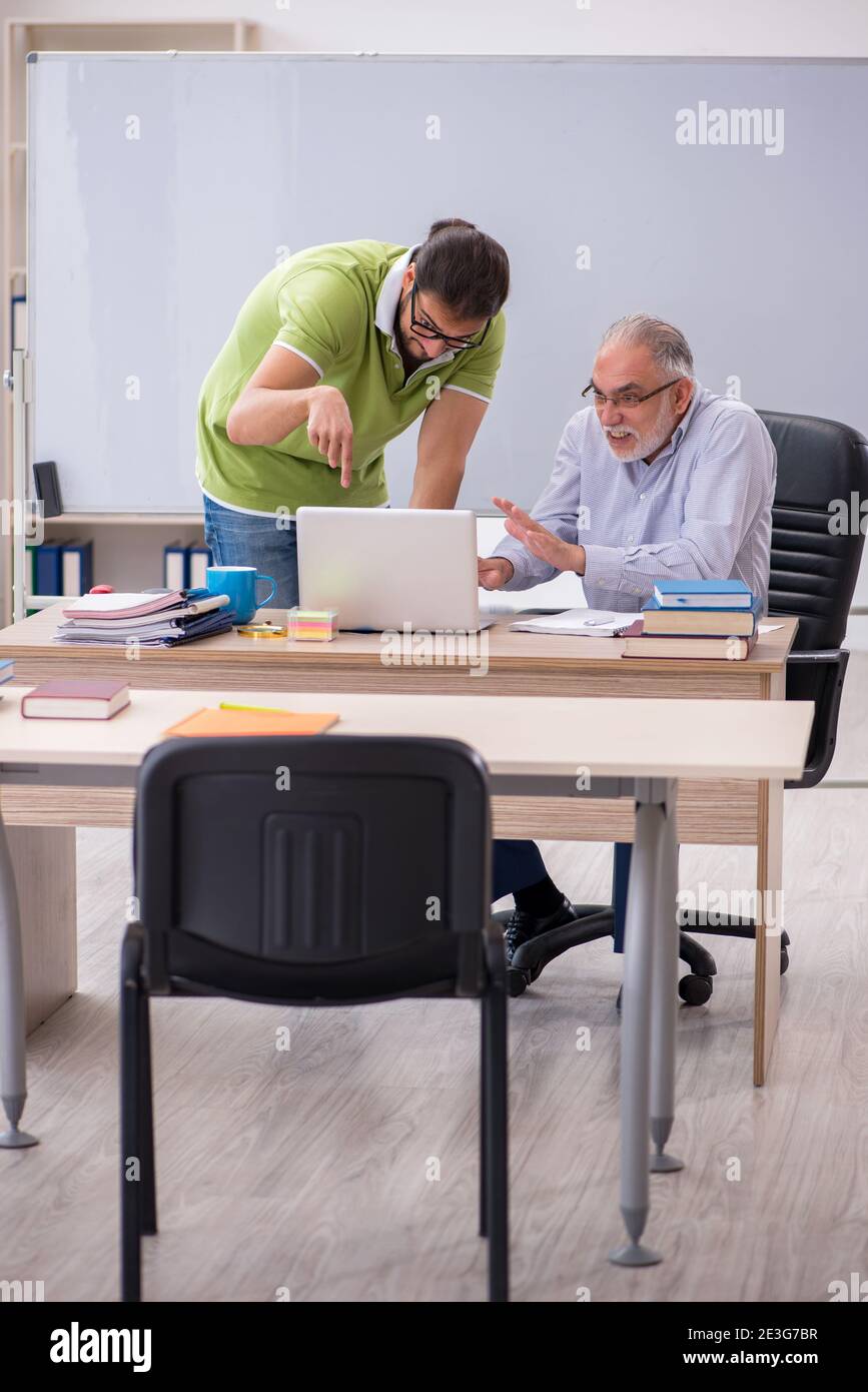 Aged male teacher and young male student in the classroom Stock Photo ...