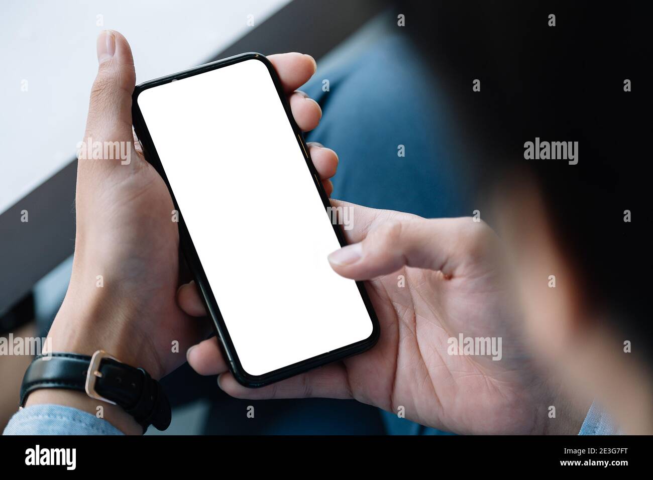 Top view Businessman sitting and holding blank screen mock up mobile ...
