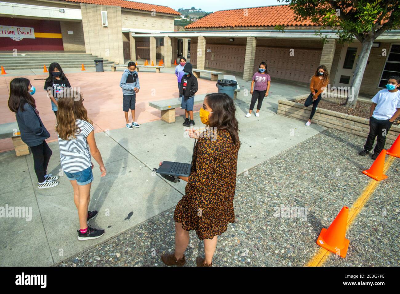 A sixth grade teacher and her multiracial class at a California middle ...