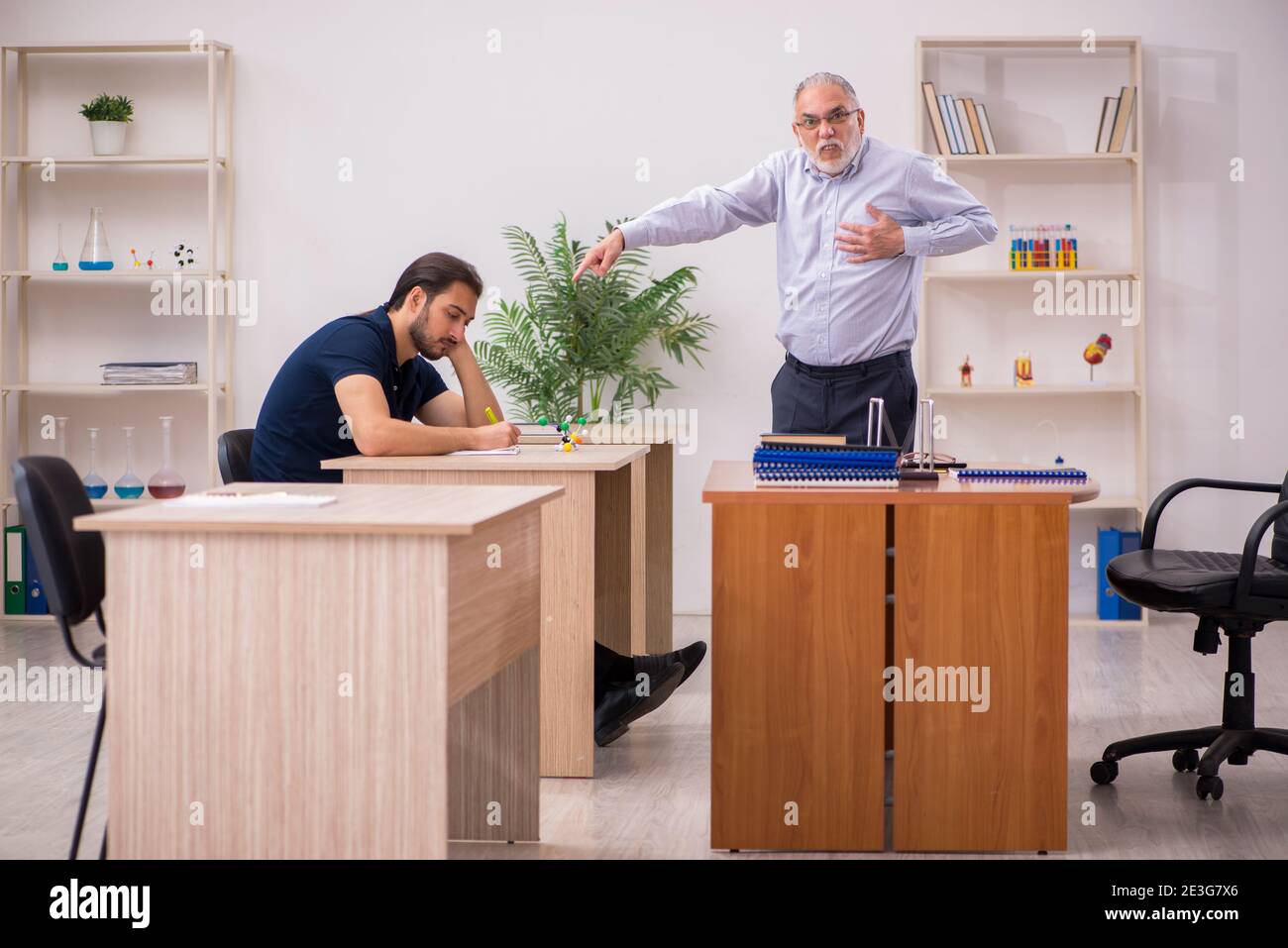 Aged male teacher feeling bad during individual lesson Stock Photo - Alamy