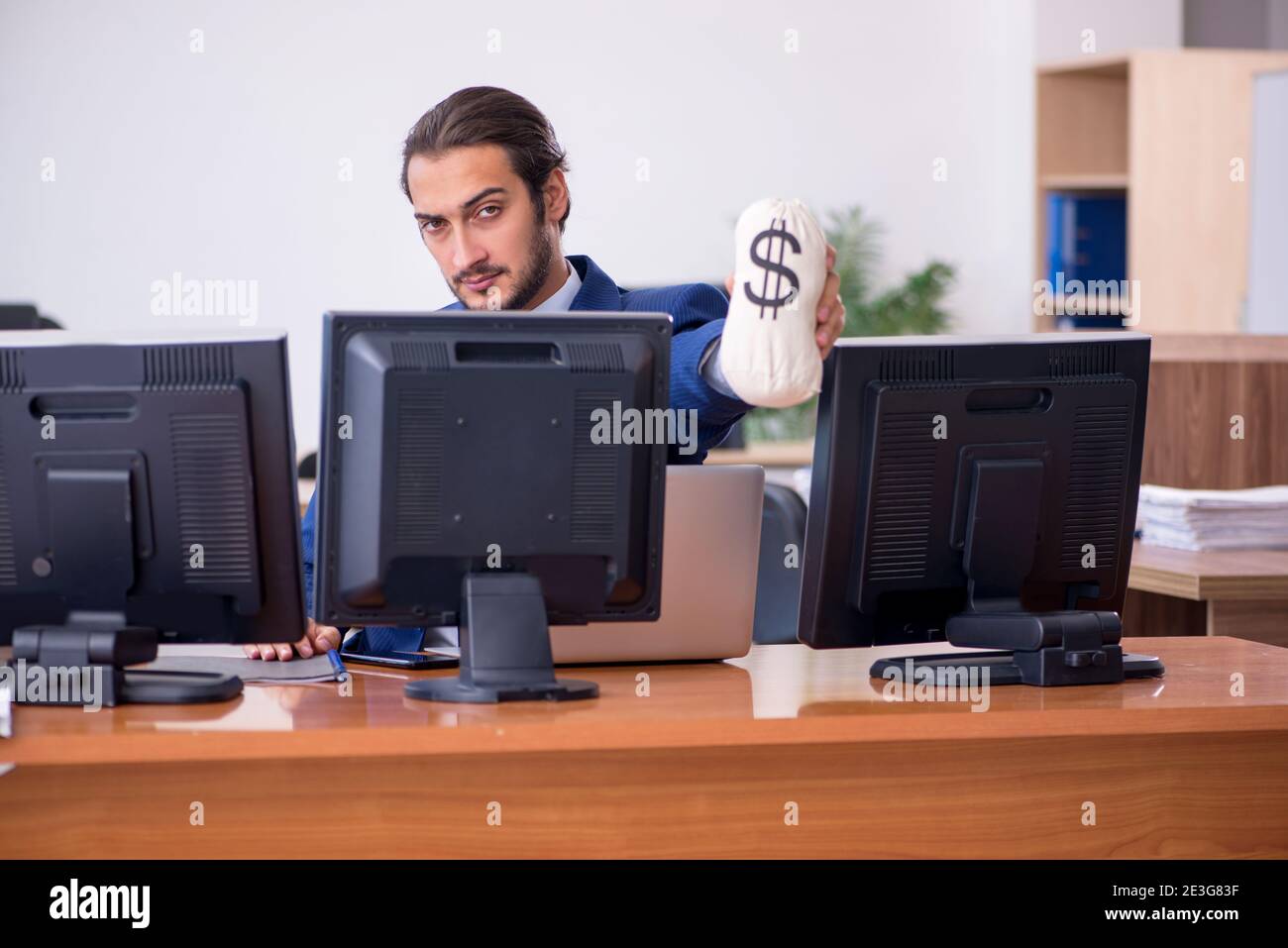 Young employee in remuneration concept Stock Photo - Alamy
