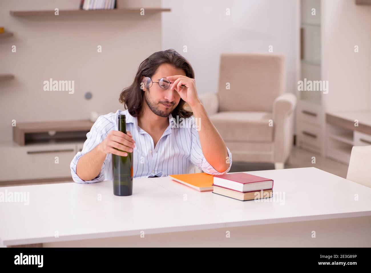 Male student drinking alcohol at home Stock Photo - Alamy