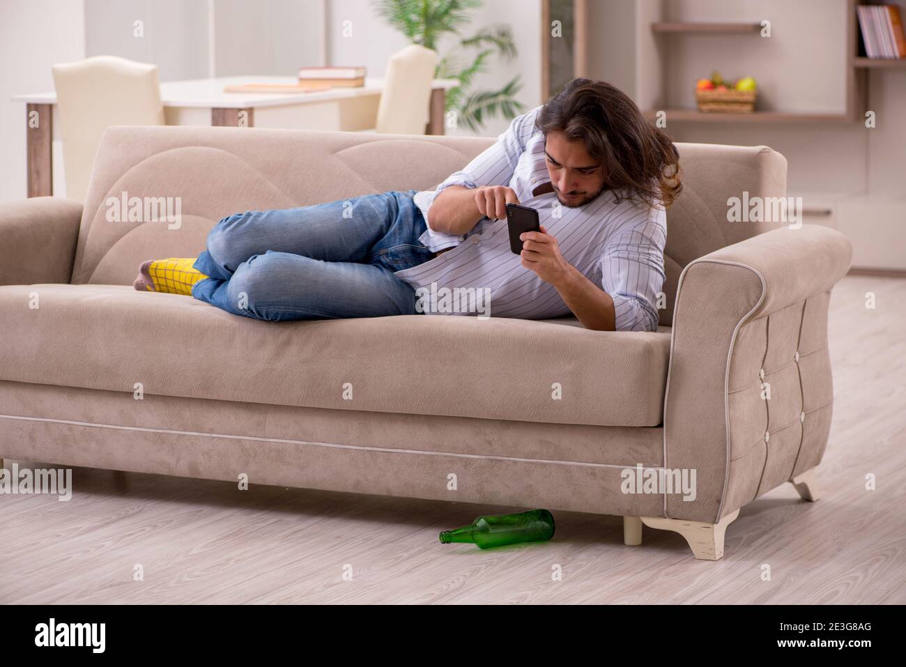 Man drinking alcohol at home Stock Photo - Alamy