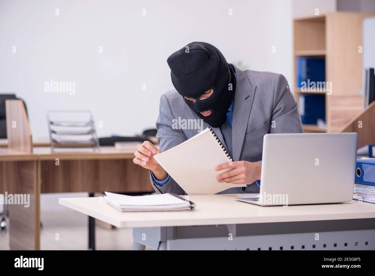 Young employee in industrial espionage concept Stock Photo - Alamy