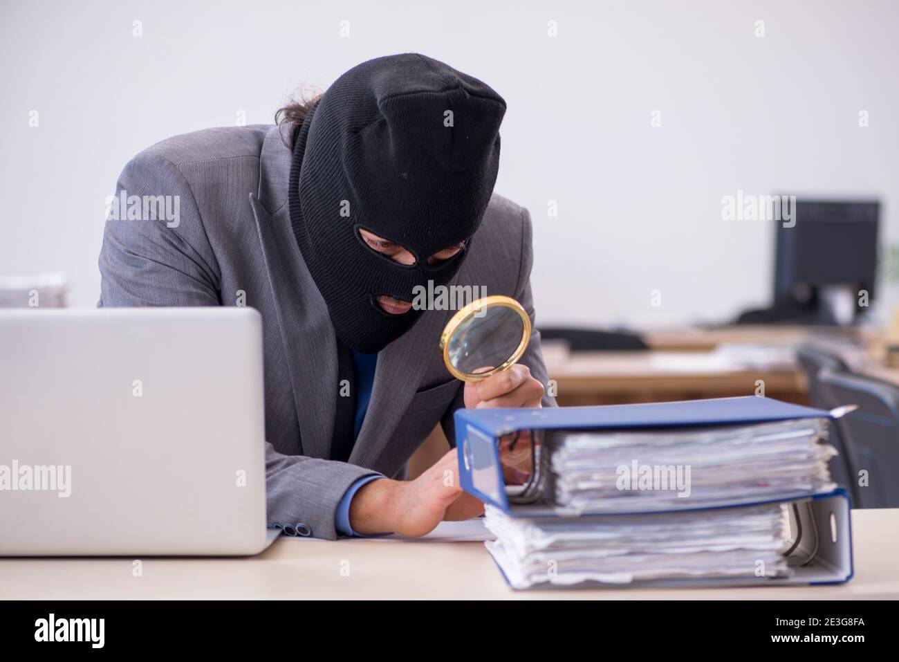 Young employee in industrial espionage concept Stock Photo - Alamy