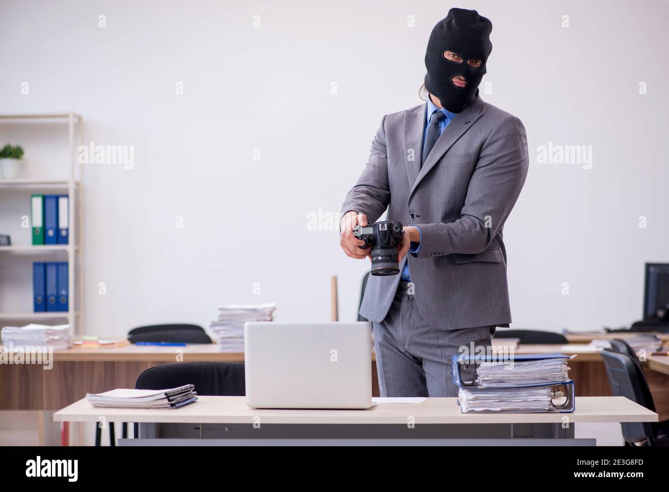 Young employee in industrial espionage concept Stock Photo - Alamy