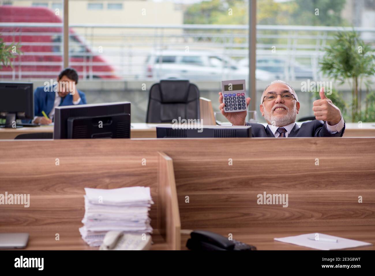 Two businessmen employees sitting in the office Stock Photo - Alamy