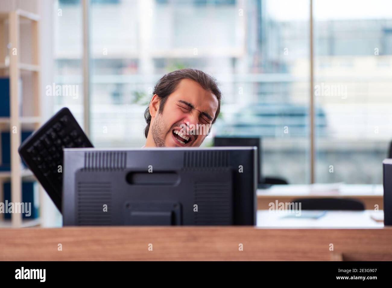 Young employee and too many work in the office Stock Photo - Alamy