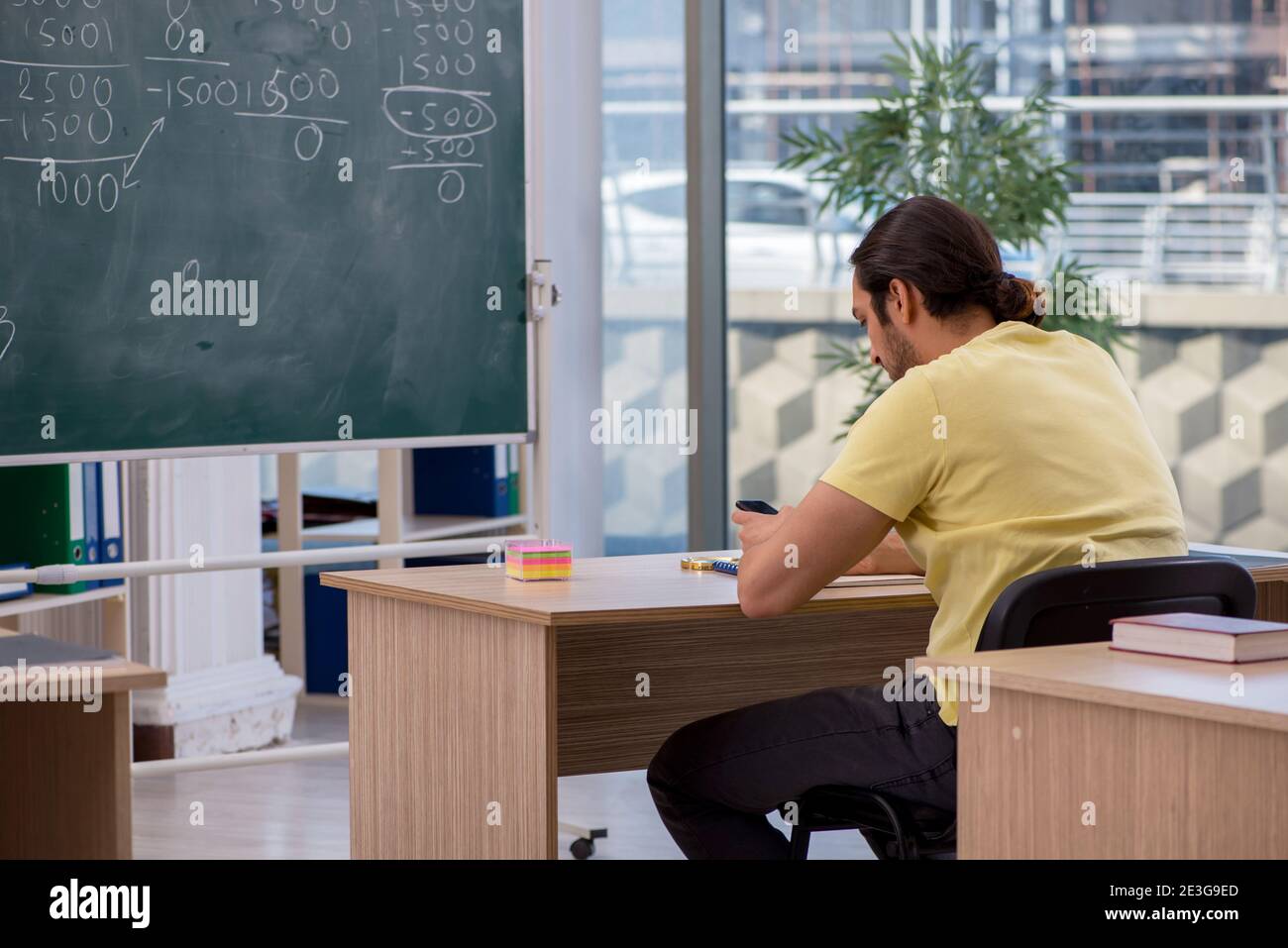 Male student sitting in the classroom Stock Photo - Alamy