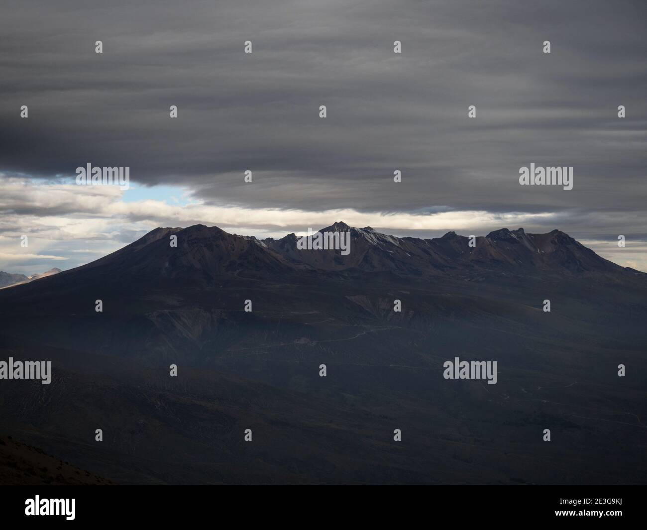 Panorama view of mountain range inactive volcano haze dust fog clouds ...