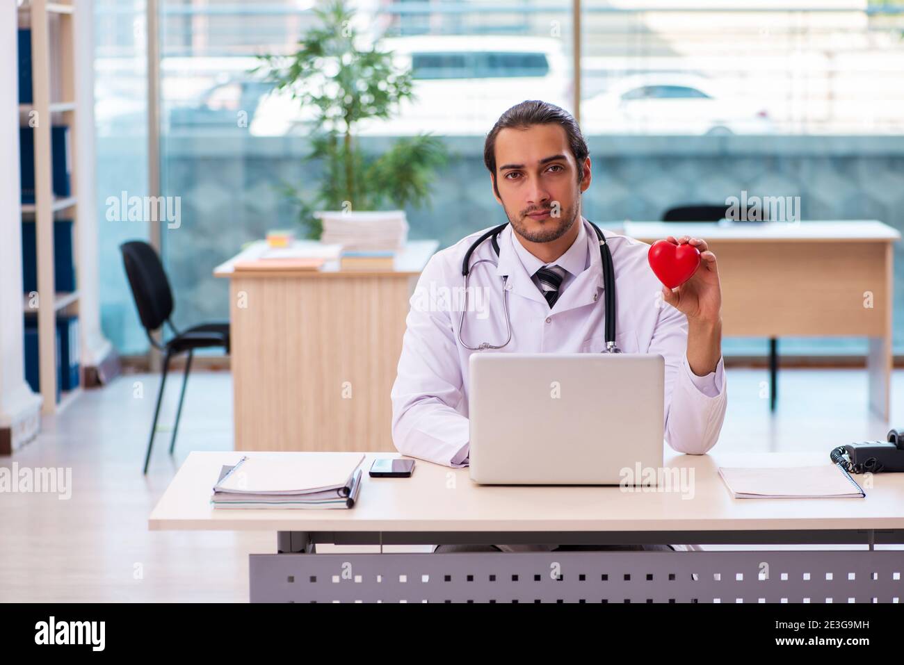 Young doctor cardiologist working in the clinic Stock Photo - Alamy