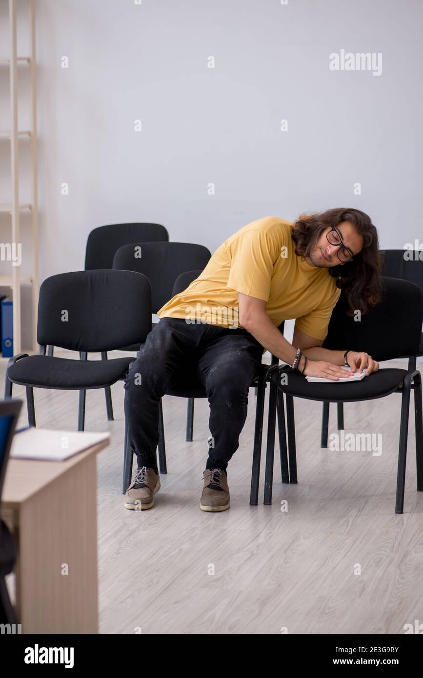 Young student waiting for teacher in the classroom Stock Photo - Alamy
