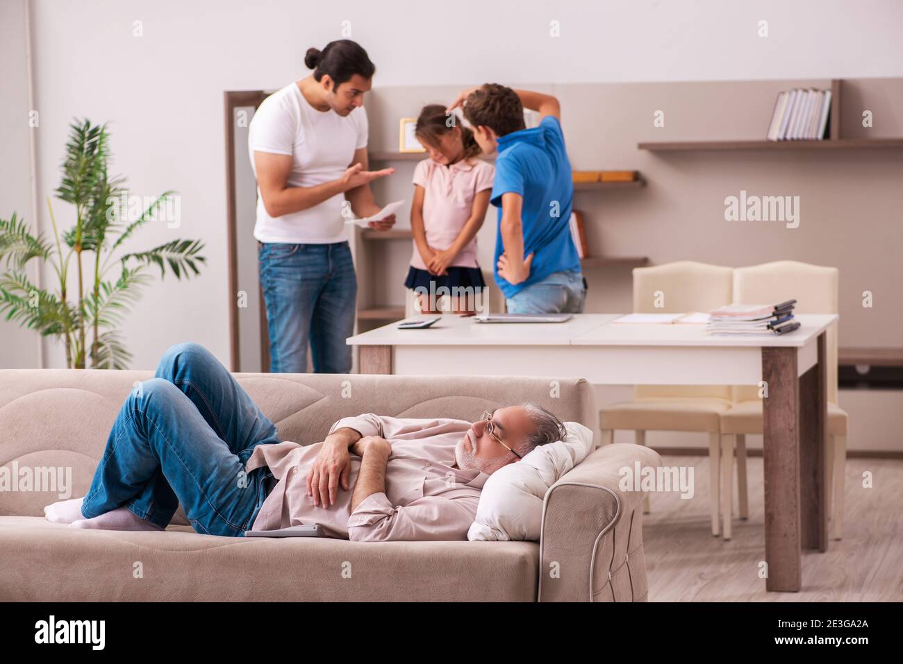 Three generations at home in early development concept Stock Photo - Alamy