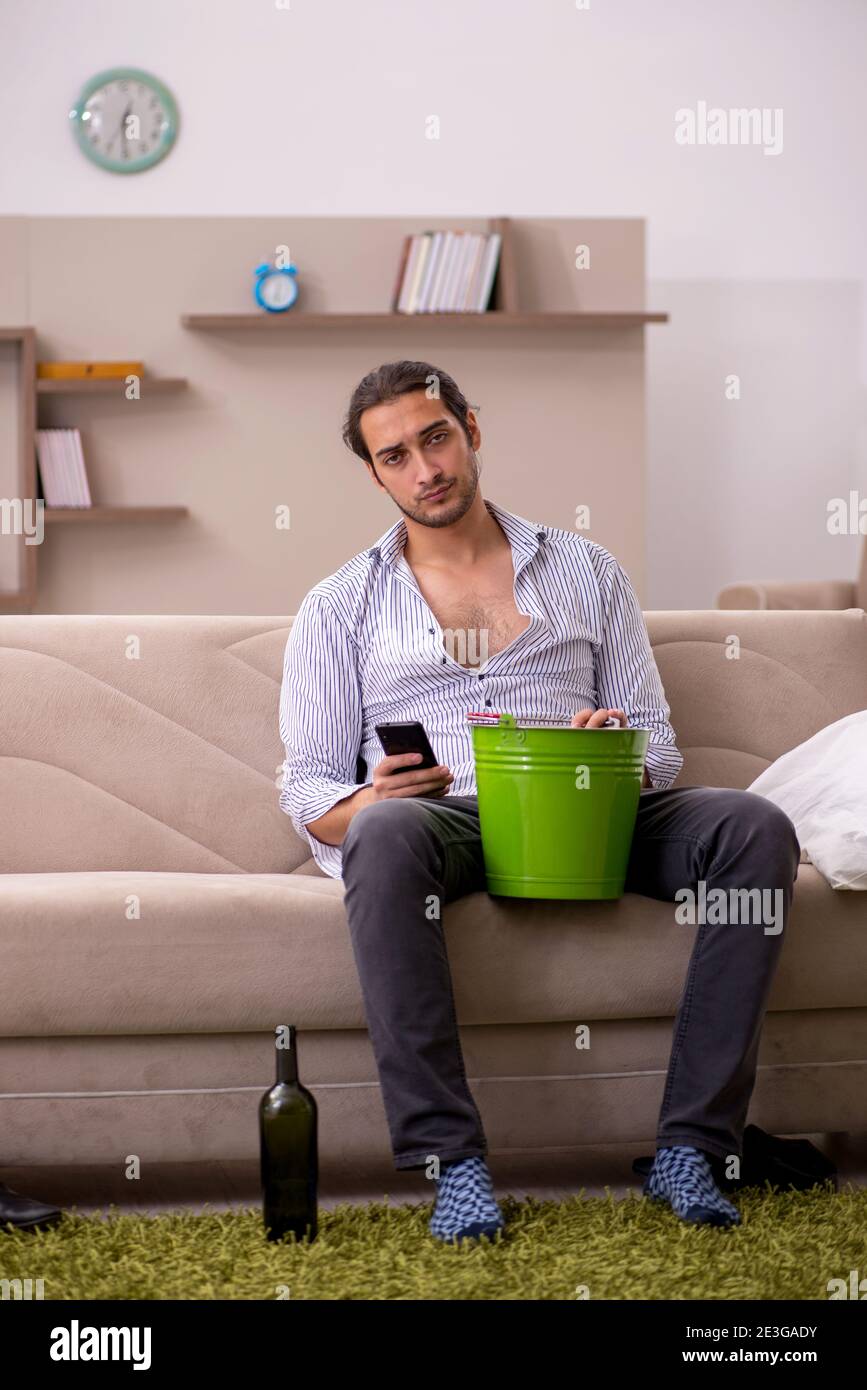 Young drunken man suffering at home Stock Photo - Alamy
