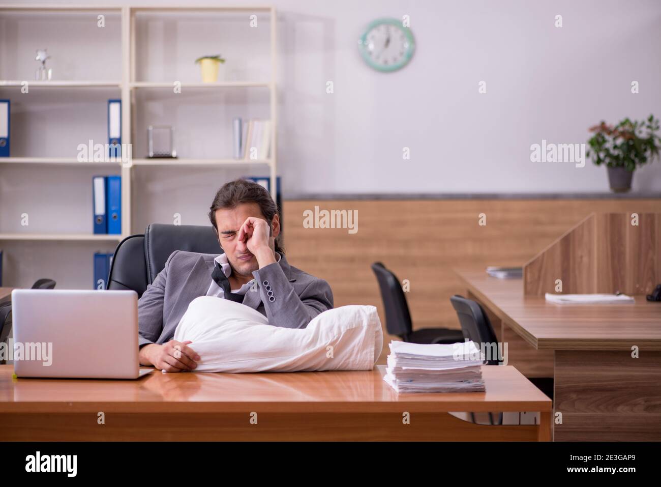 Young employee sleeping at workplace Stock Photo - Alamy