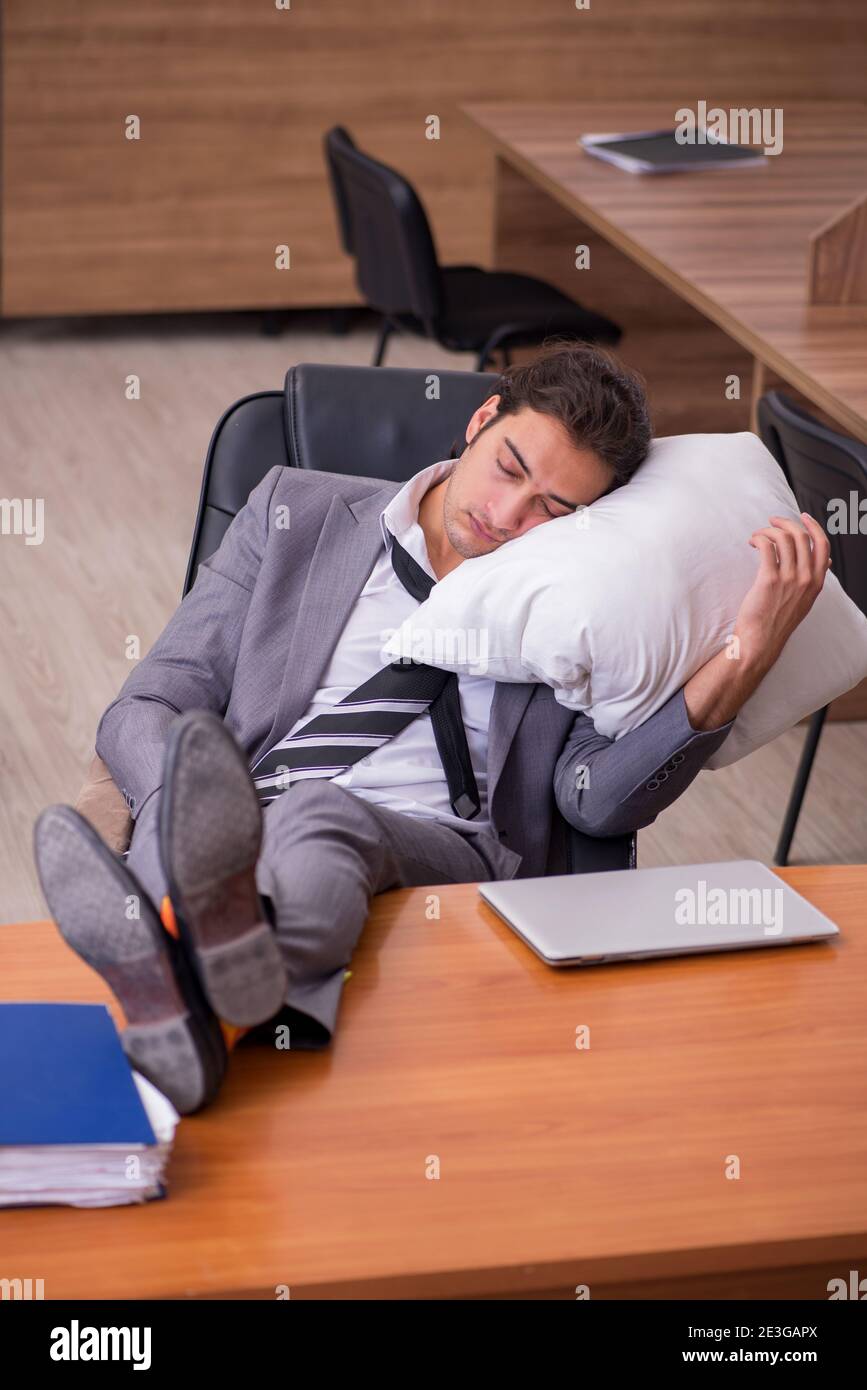 Young employee sleeping at workplace Stock Photo - Alamy