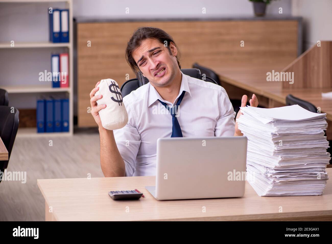 Young employee in remuneration concept Stock Photo - Alamy