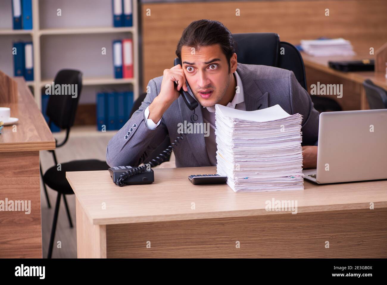 Young employee extremely tired with excessive work Stock Photo - Alamy