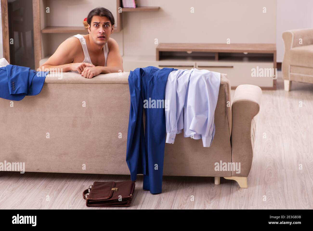 Young employee getting up late at home Stock Photo - Alamy