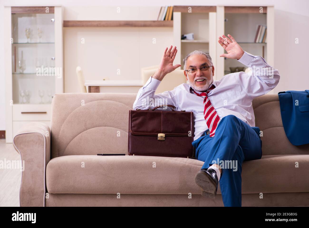 Senior male boss employee coming home from work Stock Photo - Alamy