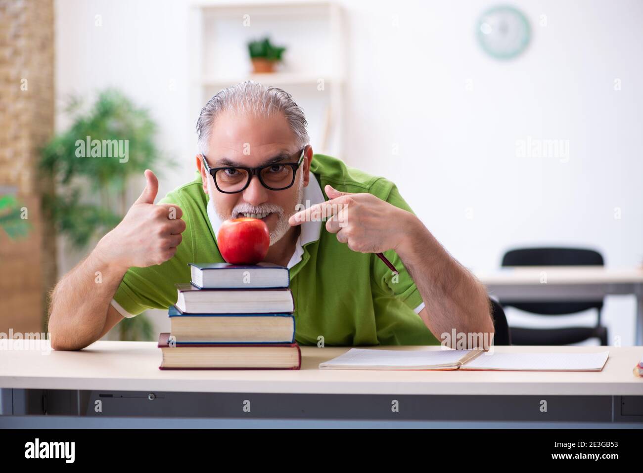 Male teacher eating apple hi-res stock photography and images - Alamy