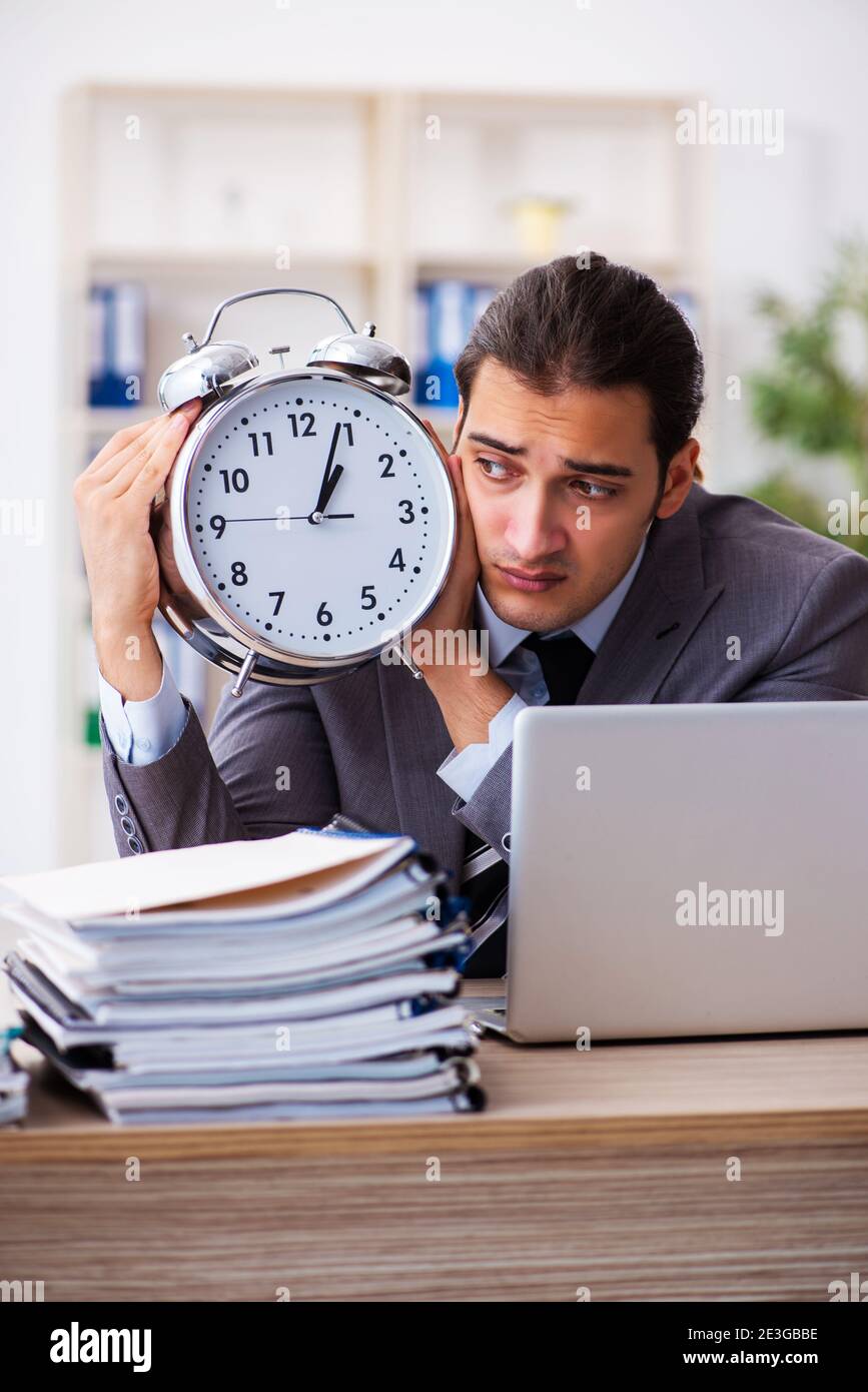 Workload employee in time management concept Stock Photo - Alamy