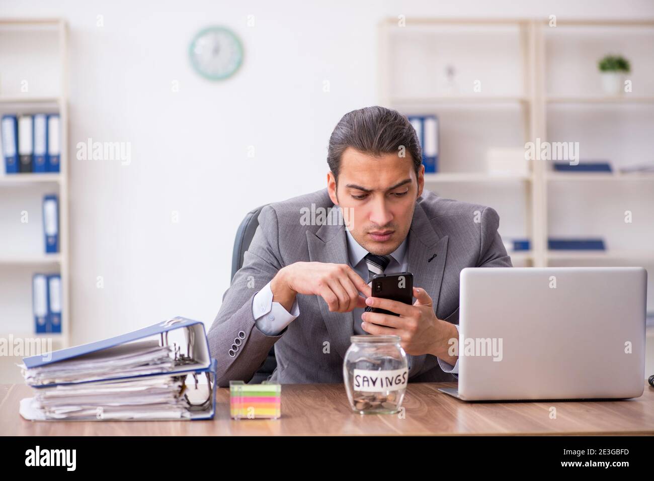 Young employee in pension concept at workplace Stock Photo - Alamy