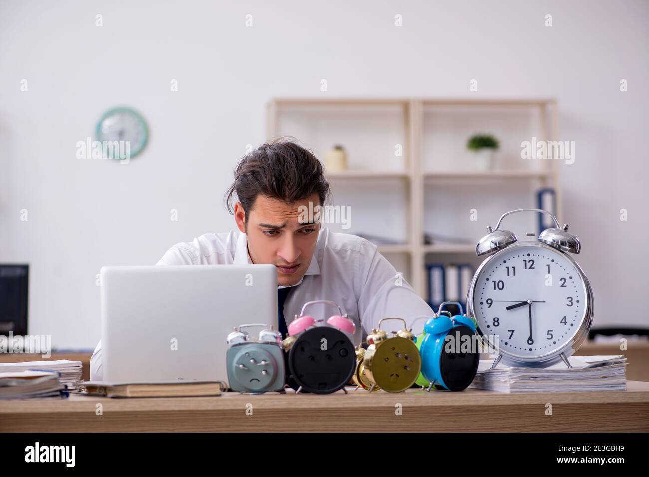 Young employee afraid of missing deadline at workplace Stock Photo - Alamy
