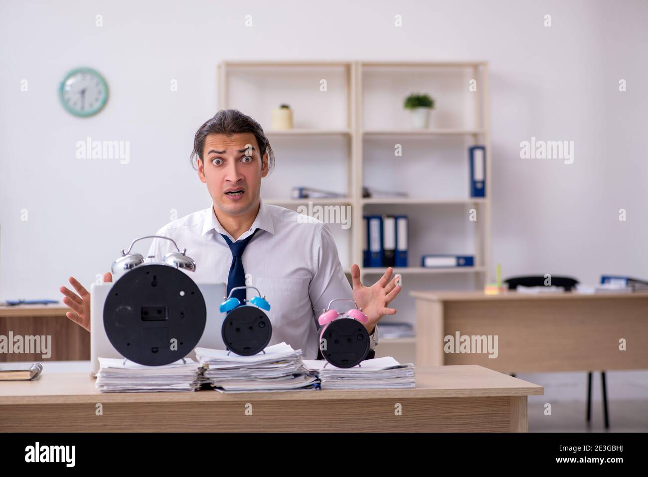 Young employee afraid of missing deadline at workplace Stock Photo - Alamy